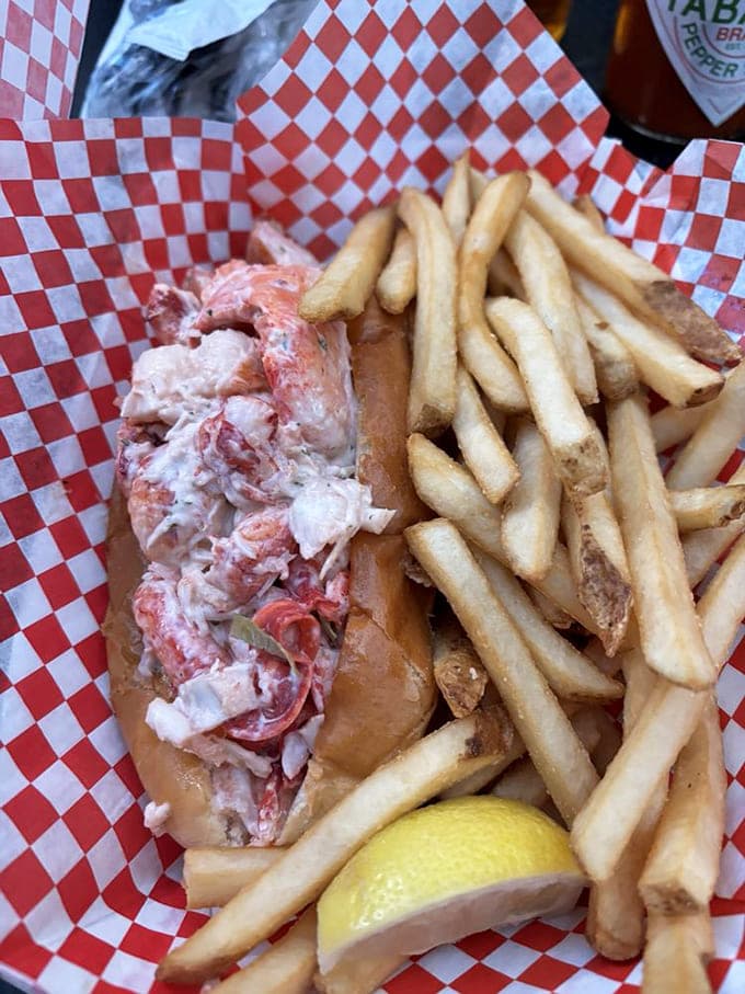 The lobster roll arrives like Neptune's gift - generous chunks of sweet meat barely contained by a perfectly toasted bun.