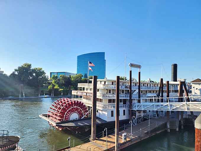 A classic paddlewheel boat docked along the river brings a touch of Mark Twain nostalgia to modern Sacramento life.
