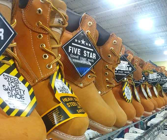 Work boots lined up like soldiers, each with stories to tell and miles left to walk. Quality footwear at prices that won't kick your budget.