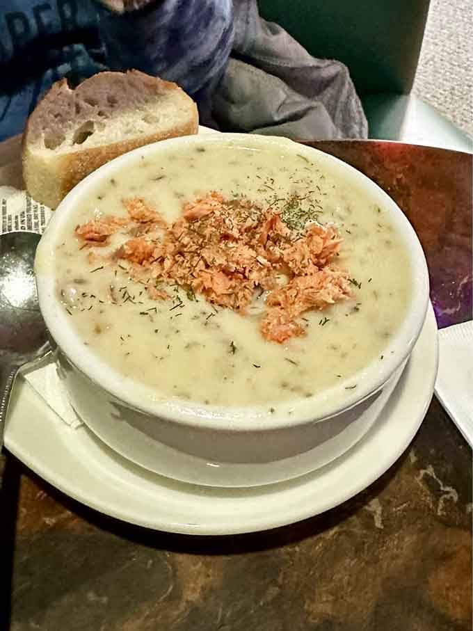 A bowl of salmon chowder that whispers, "Sit down, take a load off." Creamy, flecked with herbs, and topped with salmon morsels – winter comfort in edible form.