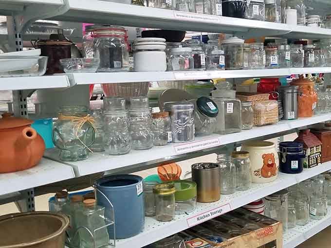 Mason jars, teapots, and kitchen containers create a collector's dream in organized, affordable chaos.