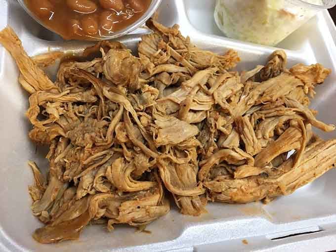 Pulled pork so tender it practically falls apart if you look at it wrong, with that perfect smoke ring of achievement.