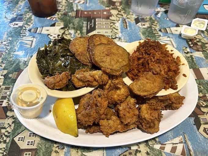 Golden fried oysters with collard greens and red rice, the holy trinity of Lowcountry cooking on one glorious plate.