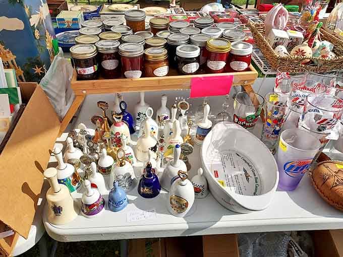 Homemade preserves and collectible bells share table space in the delightfully random way only flea markets can pull off.