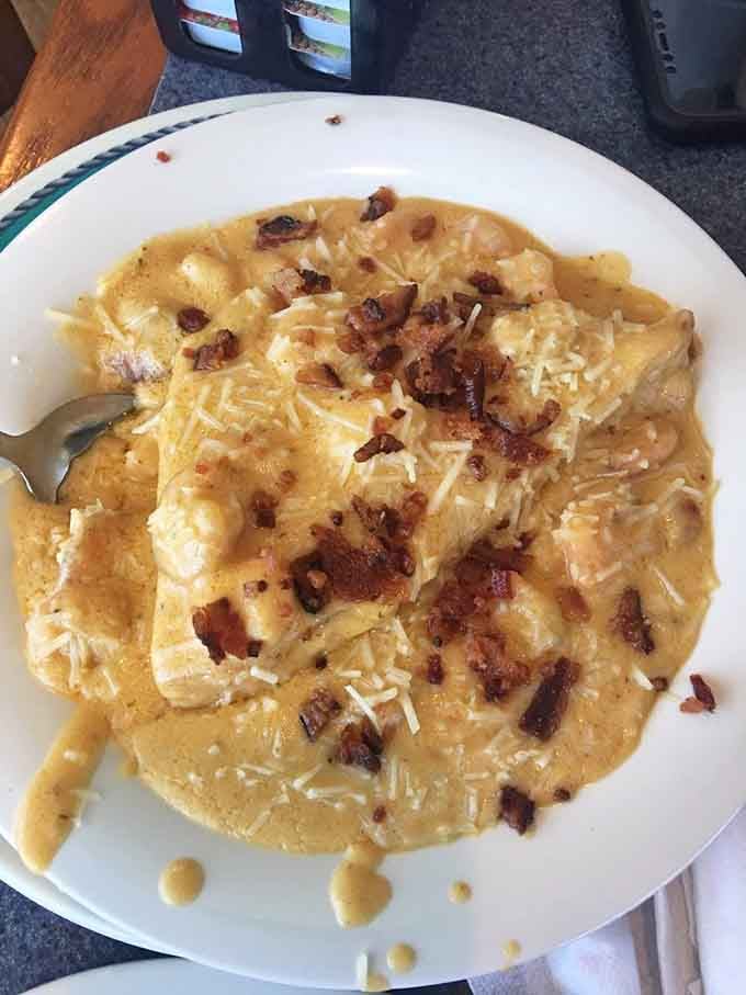 Shrimp and grits elevated to an art form &ndash; creamy, cheesy goodness topped with bacon that would make even a diet-conscious cardiologist reach for a fork.