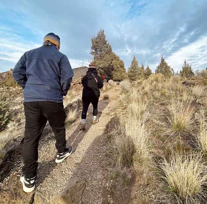 The trail beckons hikers forward through high desert terrain where every turn promises another jaw-dropping vista ahead.
