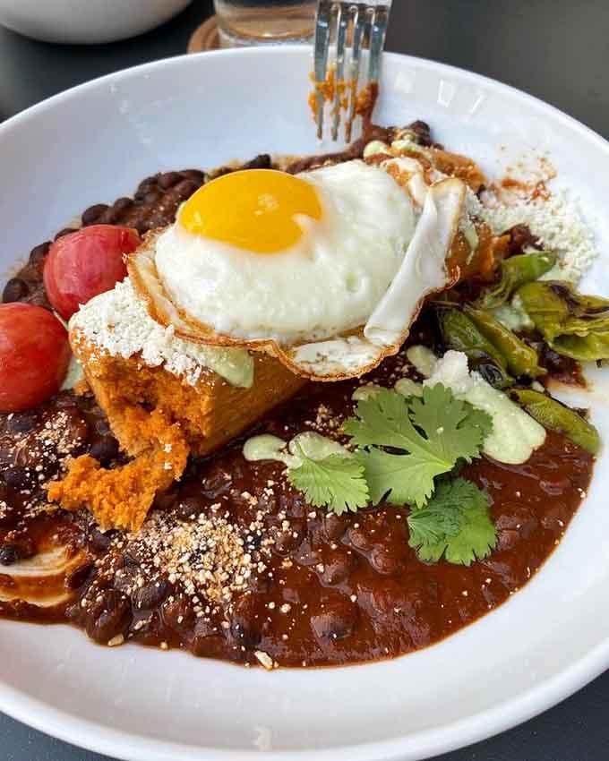 The breakfast tamale that proves Latin flavors belong at your morning table, topped with pure breakfast perfection.
