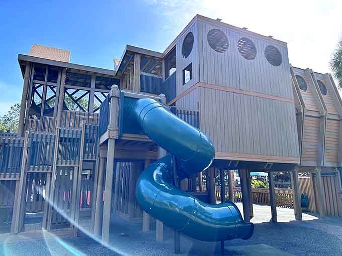 That twisty blue slide is basically a water park ride without the water, the lines, or the questionable hygiene concerns.