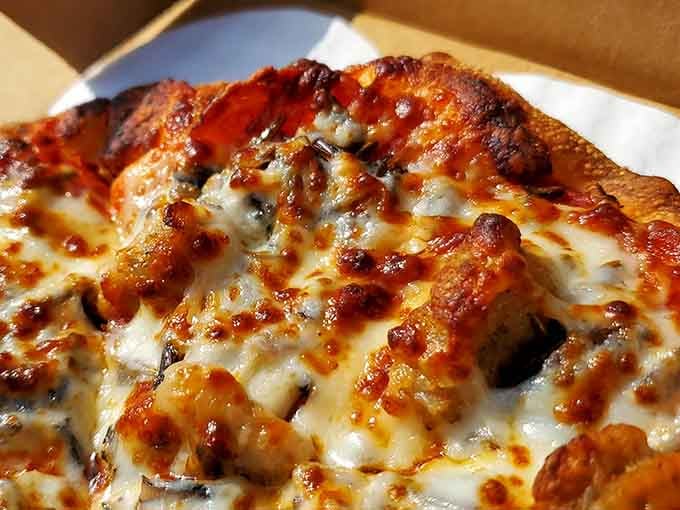 The perfect cheese-to-topping ratio captured in one glorious, melty moment that makes your mouth water.