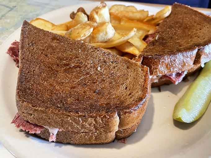 The Buffalo Reuben on rye proves that sometimes the best sandwiches require both hands and zero shame about napkin usage.