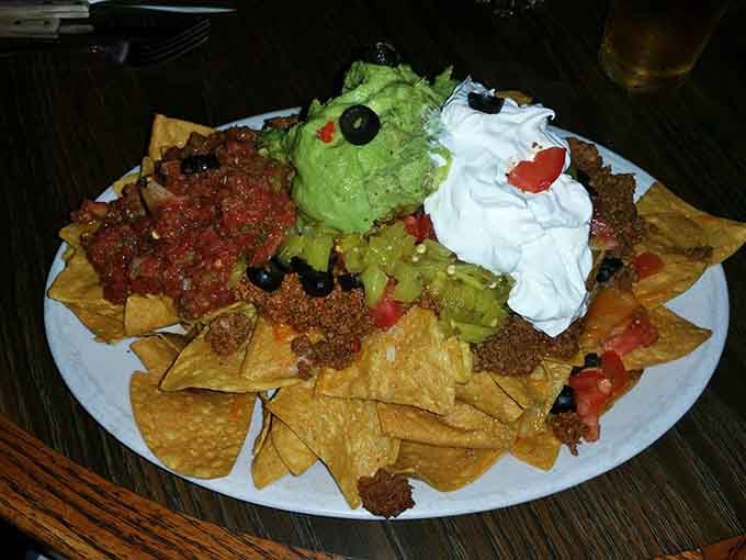 Nachos piled high with all the fixings, because even tiki bars understand the universal language of cheese.