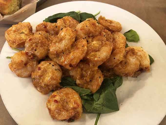Bang bang shrimp glistening on fresh greens, each piece coated in that addictive sweet-spicy glaze that demands seconds.