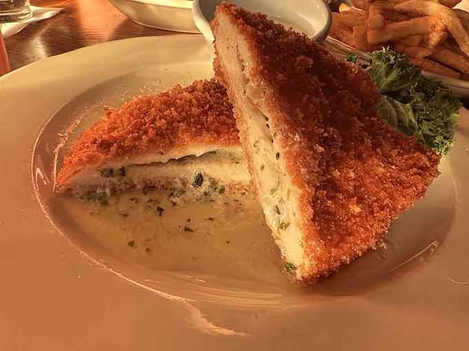 Chicken Kiev oozing butter like it's trying to win an award, because apparently it already has your heart.