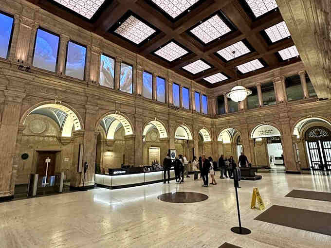 The elegant lobby space sets the stage for your journey, with coffered ceilings hinting at the architectural wonders ahead.