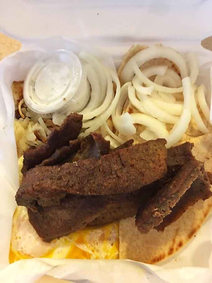 When gyro meat meets breakfast, magic happens on a plate with perfectly cooked eggs and onions.