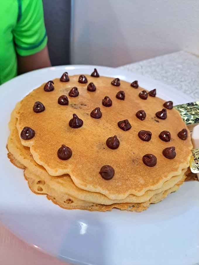 Chocolate chip pancakes arranged like edible polka dots, proving breakfast can be both art and delicious.
