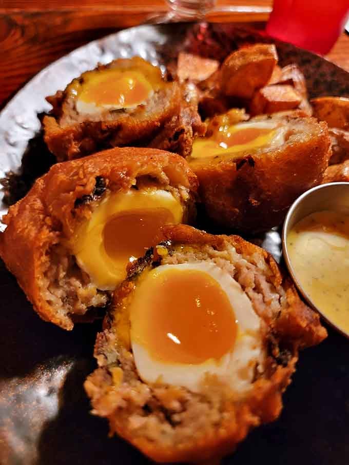 These scotch eggs at The Sparrow & Serpent feature perfectly runny yolks wrapped in savory, crispy perfection.