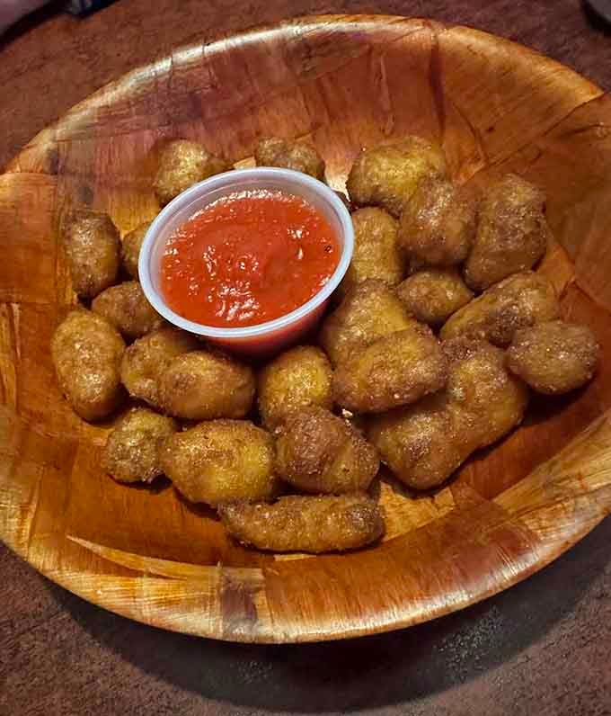 Golden tater tots arrive like tiny pillows of joy, perfect for the burger intermission you'll desperately need.