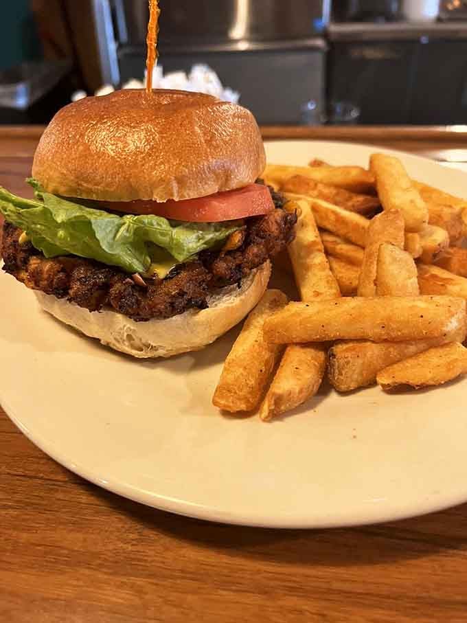 That black bean burger sits pretty with its fries, proving vegetarian options don't have to play second fiddle.