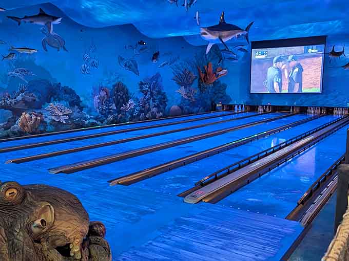 Blue lighting transforms ordinary bowling into an oceanic adventure, making gutter balls feel almost poetic and intentional.