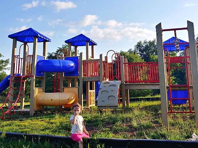 Playground equipment in bright primary colors means kids can burn energy while parents enjoy actual conversations on nearby benches.