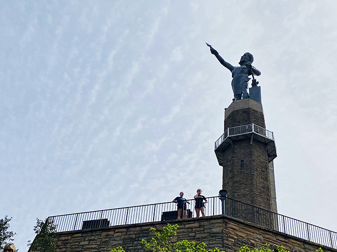 Visitors crane their necks to take in all 56 feet of iron magnificence, probably wondering how they fit him through airport security.