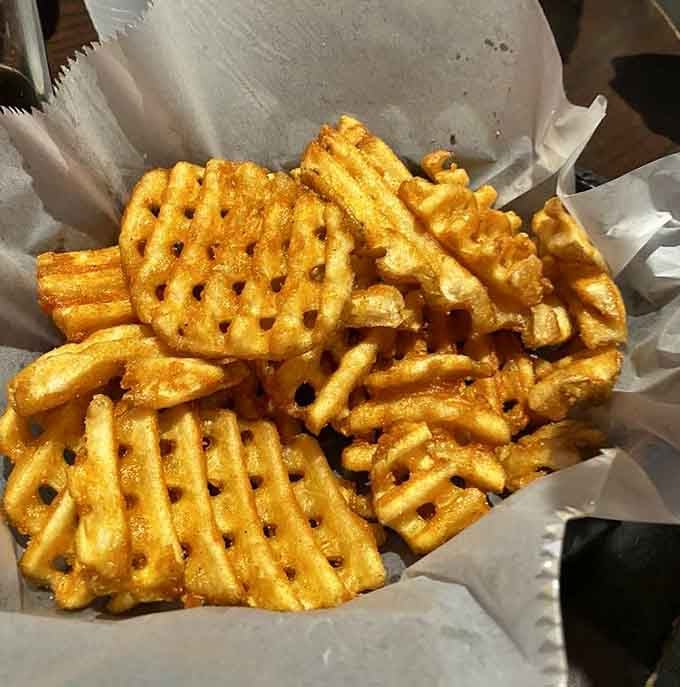 Golden waffle fries achieve that perfect balance of crispy exterior and fluffy interior that makes carbs completely worth it.