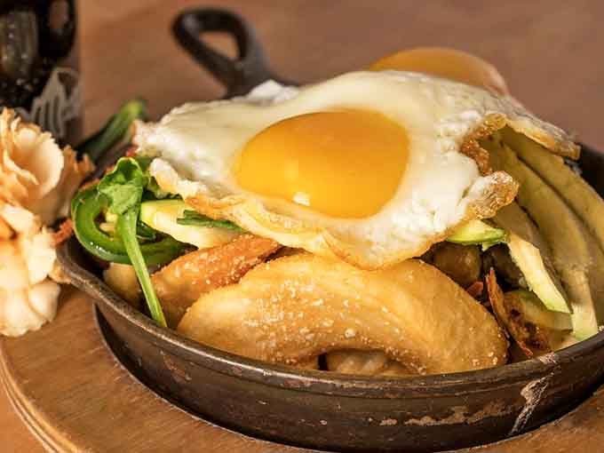 A sizzling skillet topped with a perfectly fried egg makes vegetables look like the rockstars they were always meant to be.