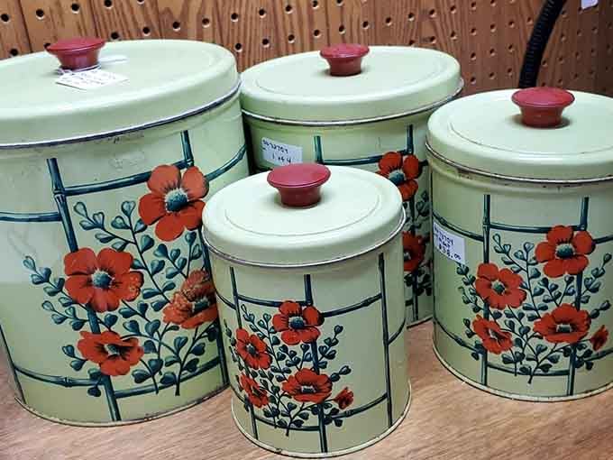 Metal canisters in mint green with cheerful flowers, because kitchens used to understand the assignment of being pretty.