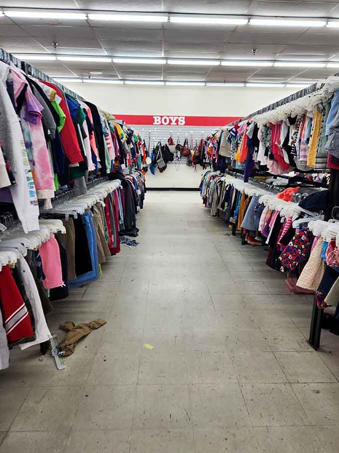 The boys' section stretches into the distance like a textile highway. Each hanger potentially holds someone's future favorite t-shirt or lucky jacket.