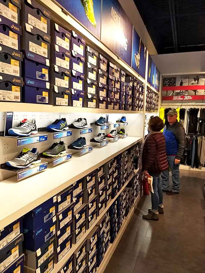 The wall of athletic footwear stands like a monument to human ambition. Each box contains not just shoes, but the promise of becoming your better self.