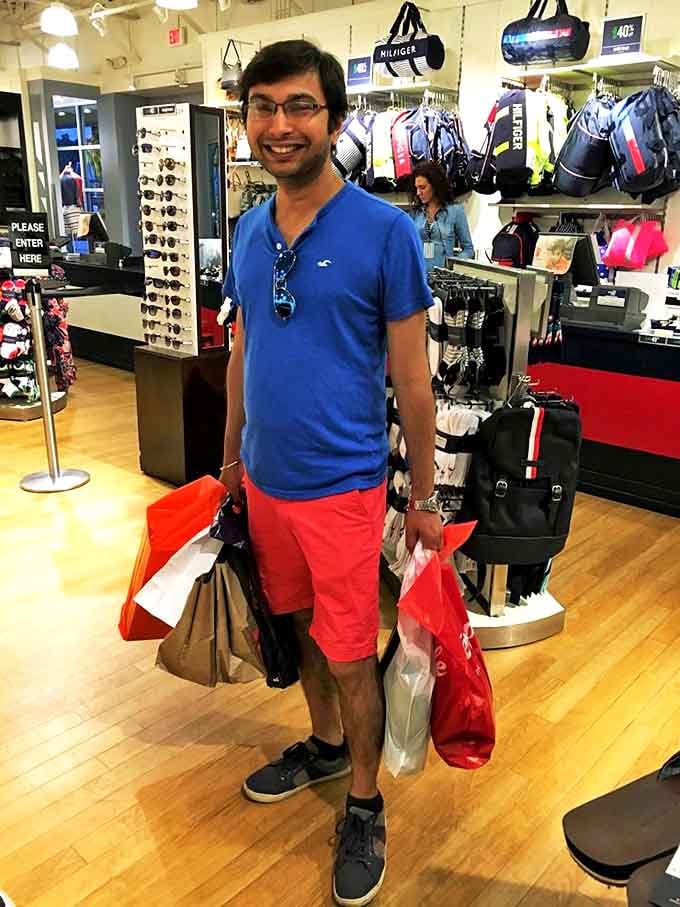 The universal "successful shopping trip" smile says it all. Those bags aren't carrying themselves, but the deals were worth every step.