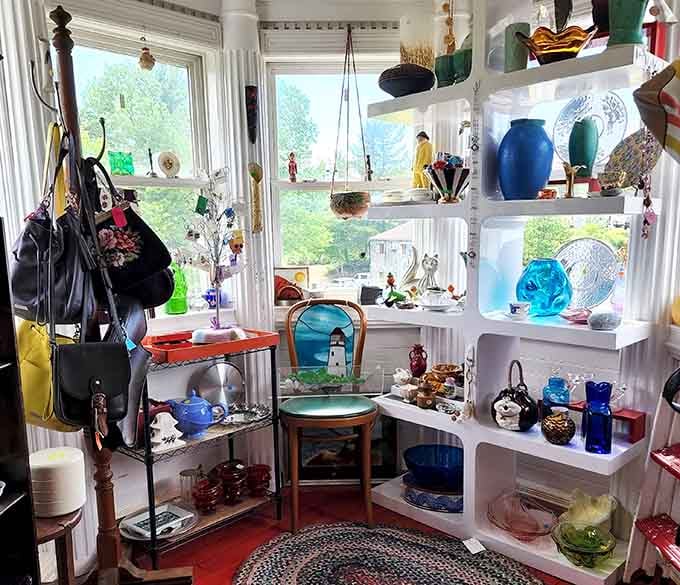 Sunlight streams through windows illuminating colorful glassware displays – a kaleidoscope effect that makes ordinary objects extraordinary.