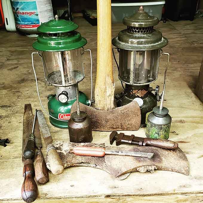 Vintage Coleman lanterns and weathered hand tools tell stories of camping trips past, back when people actually knew how to fix things themselves.