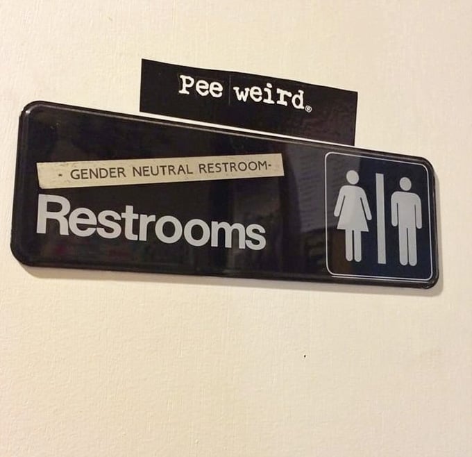 Even the restroom signage at Fat Rabbit refuses to be ordinary, proving that personality and humor extend to every corner of this Louisville gem.