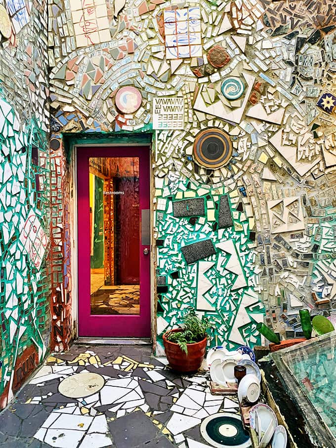 Even the restroom deserves the royal treatment. This doorway proves that at Magic Gardens, functionality never trumps artistic expression.