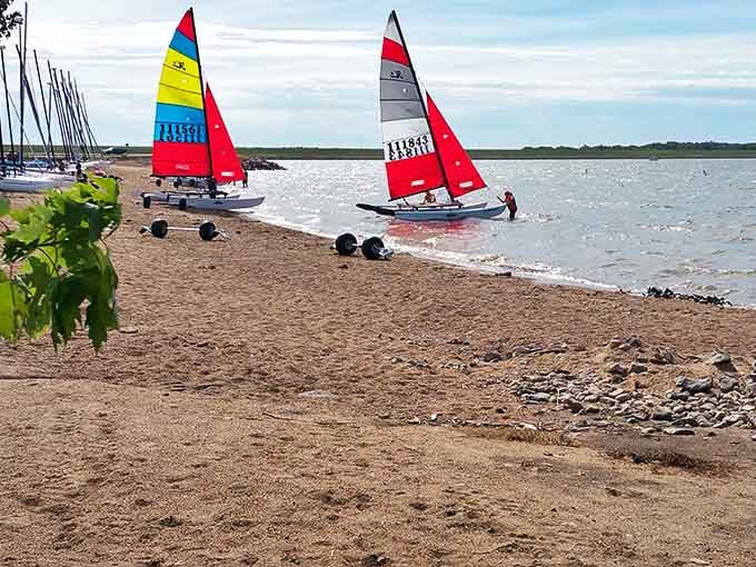 Colorful sails dot the shoreline like confetti on water, proving South Dakota knows how to throw a party that doesn't involve snow shovels.