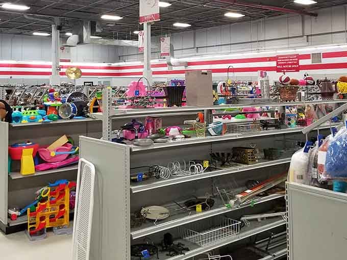 Bright warehouse lighting illuminates endless rows of housewares where yesterday's kitchen becomes tomorrow's vintage treasure collection today.