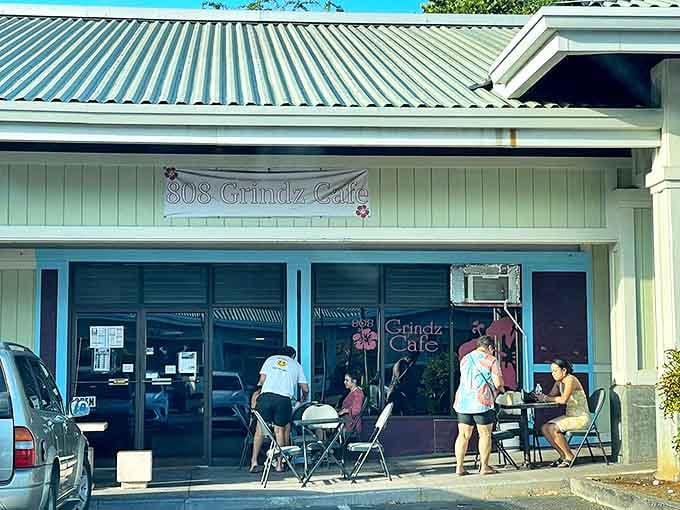 808 Grindz Cafe's cheerful exterior welcomes hungry visitors. The pale mint building houses breakfast magic worth waking up early for.