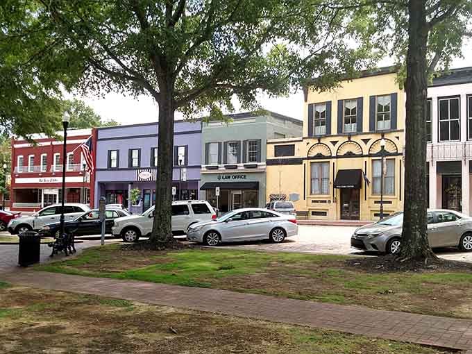 Painted storefronts in cheerful colors line a town square where neighbors still know each other's names.