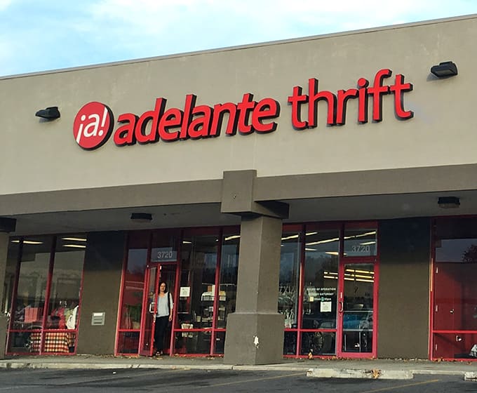 Adelante Thrift's vibrant red signage pops against the neutral building, promising a fiesta of finds inside.