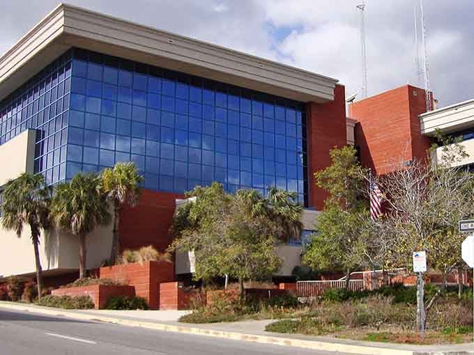 Modern glass meets Florida palms in an unexpected architectural moment that somehow works beautifully together.