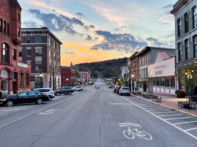 Sunset transforms the main street into a painter's dream with pink and orange clouds dancing above historic buildings.
