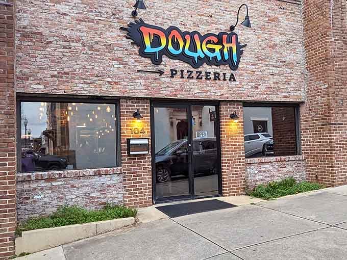 Dough's colorful, graffiti-style logo pops against historic brick walls. Modern flavors in a timeless Opelika setting!