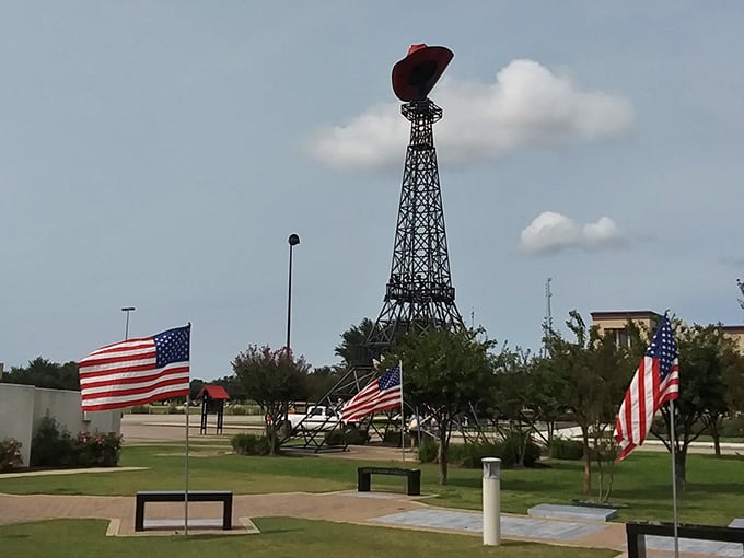 That giant red cowboy hat perched on top announces this isn't your typical Parisian landmark, partner.
