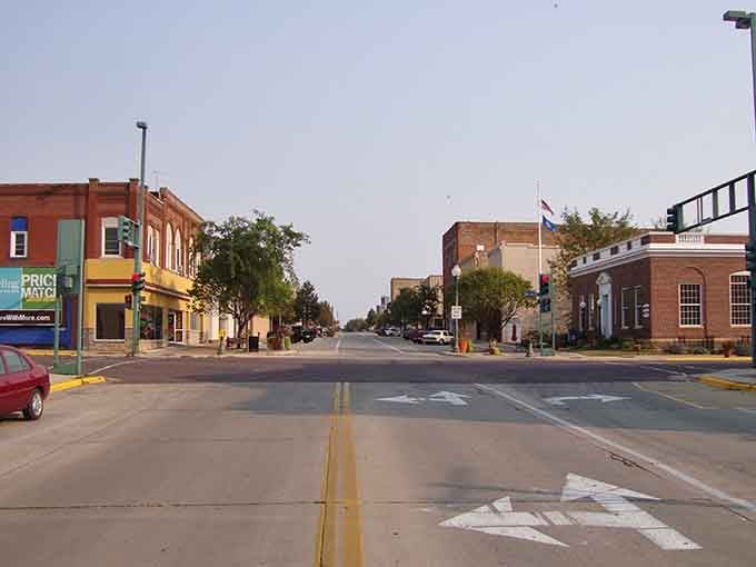 Golden hour light bathes the storefronts in warmth, making even a simple errand feel like a pleasant evening adventure.
