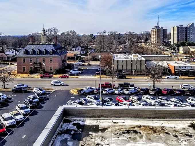 Historic buildings frame a parking lot view that somehow captures the essence of small-town Alabama life.