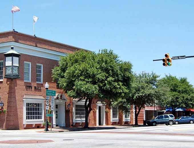 City Hall stands under mature oaks, where local government still feels accessible and the pace remains wonderfully unhurried.