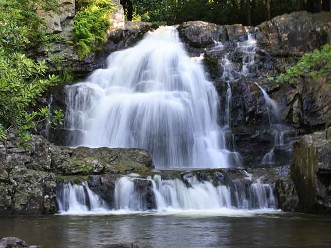 Hawk Falls pours over its ledge into a crystal-clear pool surrounded by moss-covered boulders perfect for contemplating life.