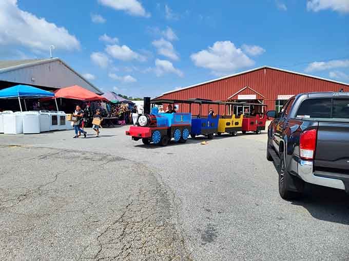 That little train chugging through the parking lot adds whimsy to your bargain-hunting expedition under blue skies.
